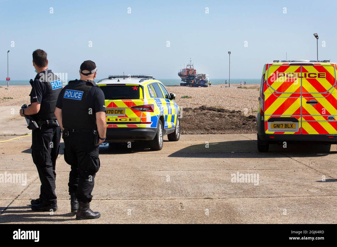 Police with migrants on beach hi-res stock photography and images - Alamy