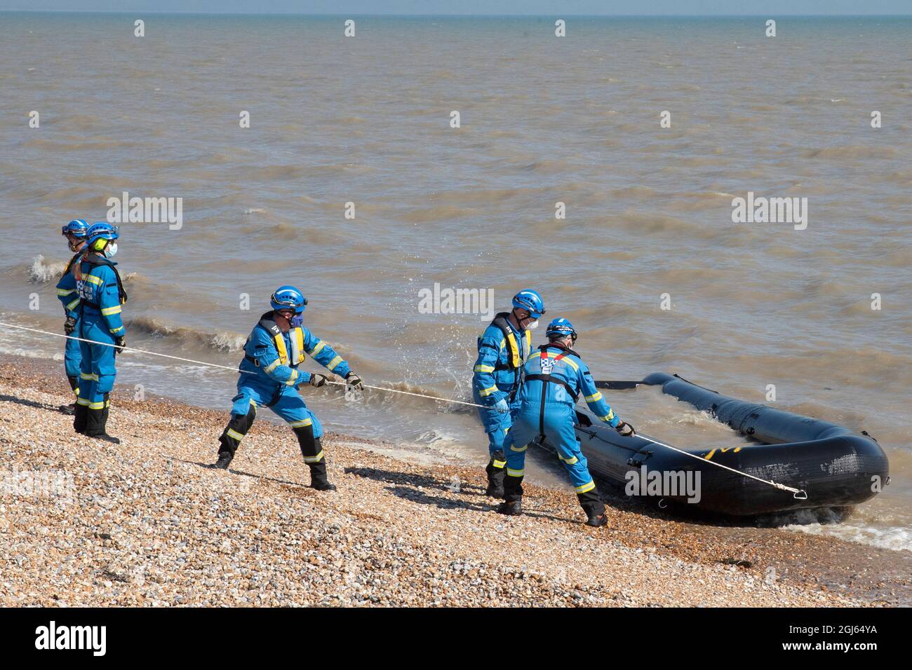 Police with migrants on beach hi-res stock photography and images - Alamy