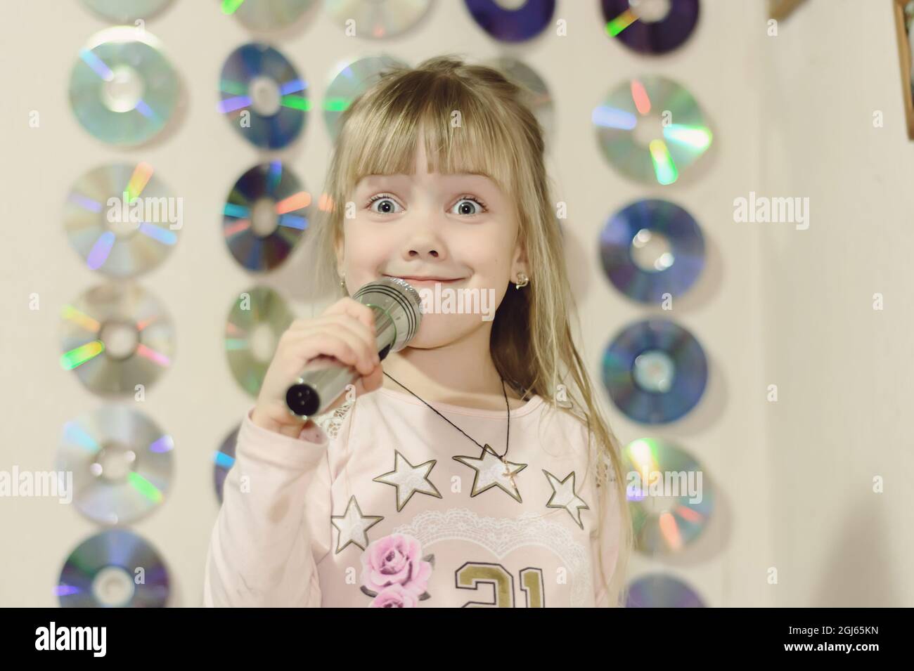 Little girl with microphone Stock Photo - Alamy