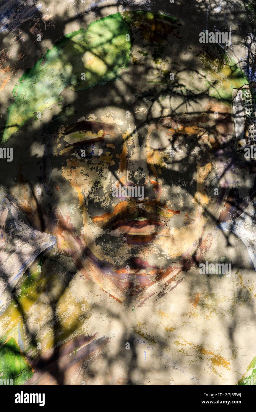 Ukraine, Pripyat, Chernobyl. Faded Soviet mural. Close-up of a soldier ...