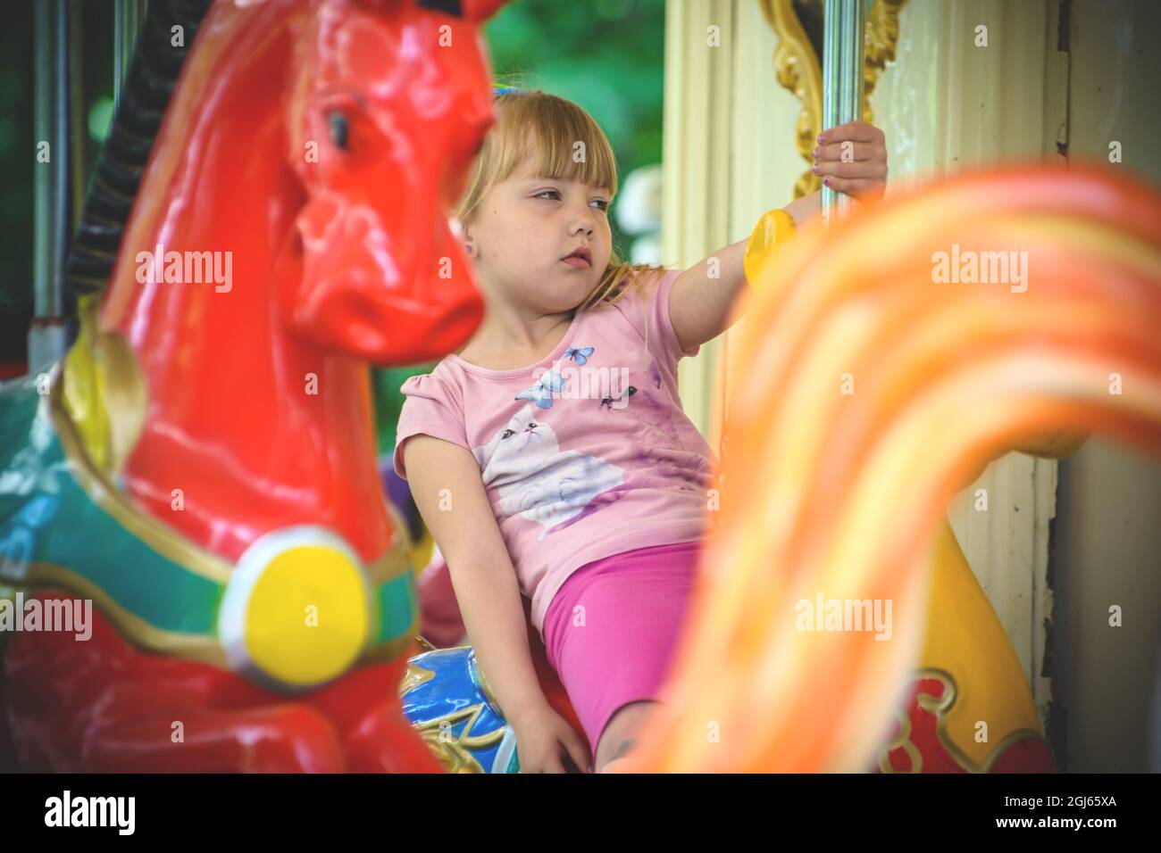 Young girl riding carousel horse hi-res stock photography and images ...