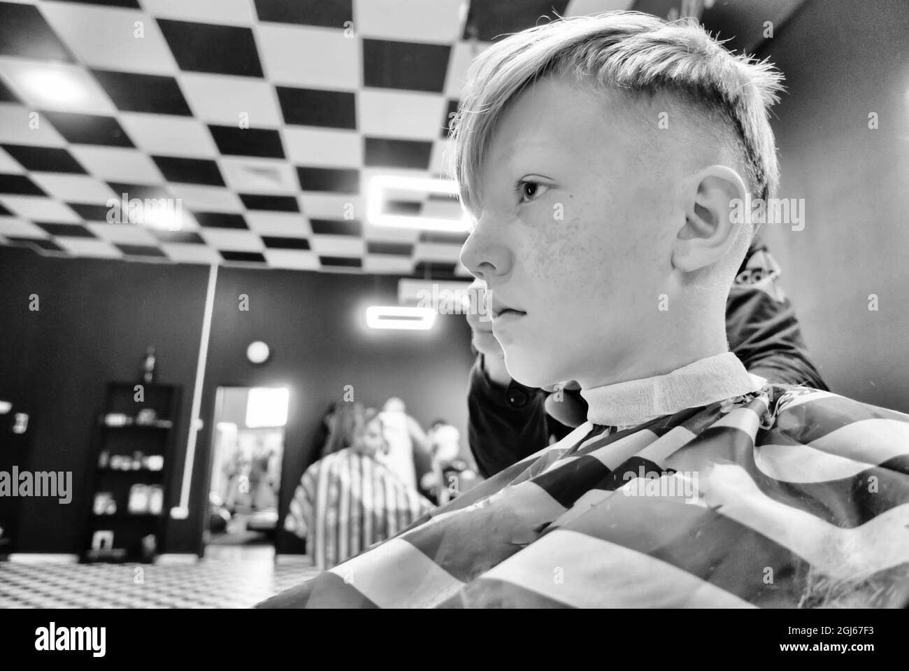 The boy is sheared in the barbershop Stock Photo - Alamy