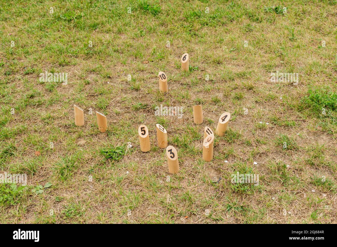 Wooden sticks with numbers on the ground for a game Stock Photo - Alamy