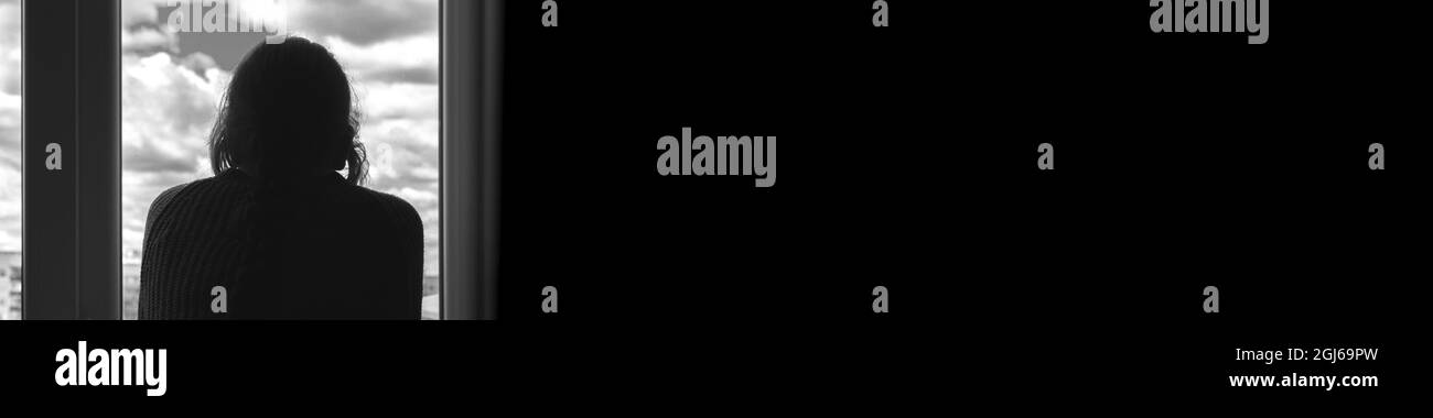 Woman silhouette and window sill. Moody cozy banner with copy space ...