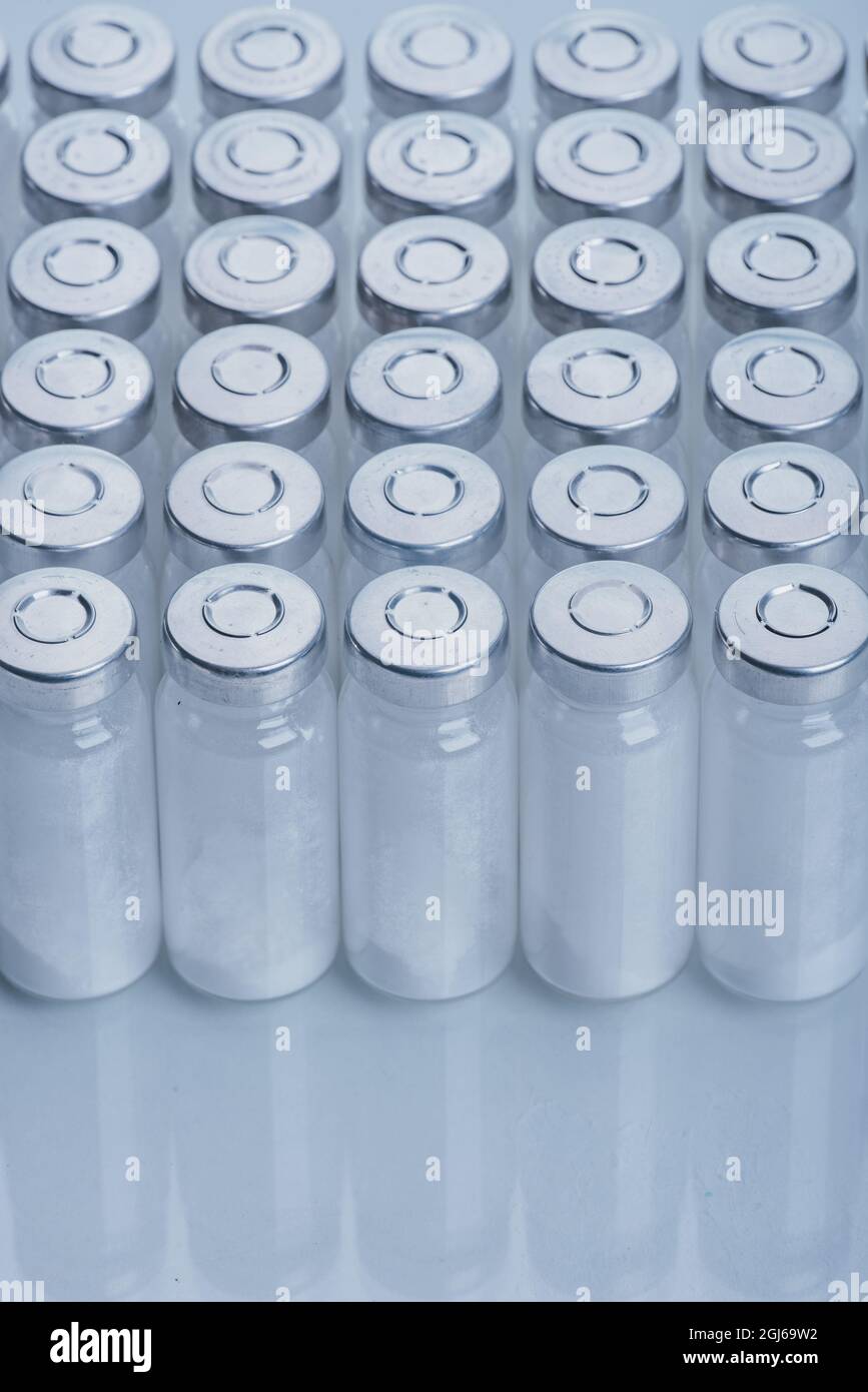 Glass medical ampoule vial for injection. Medicine is dry white drug ...