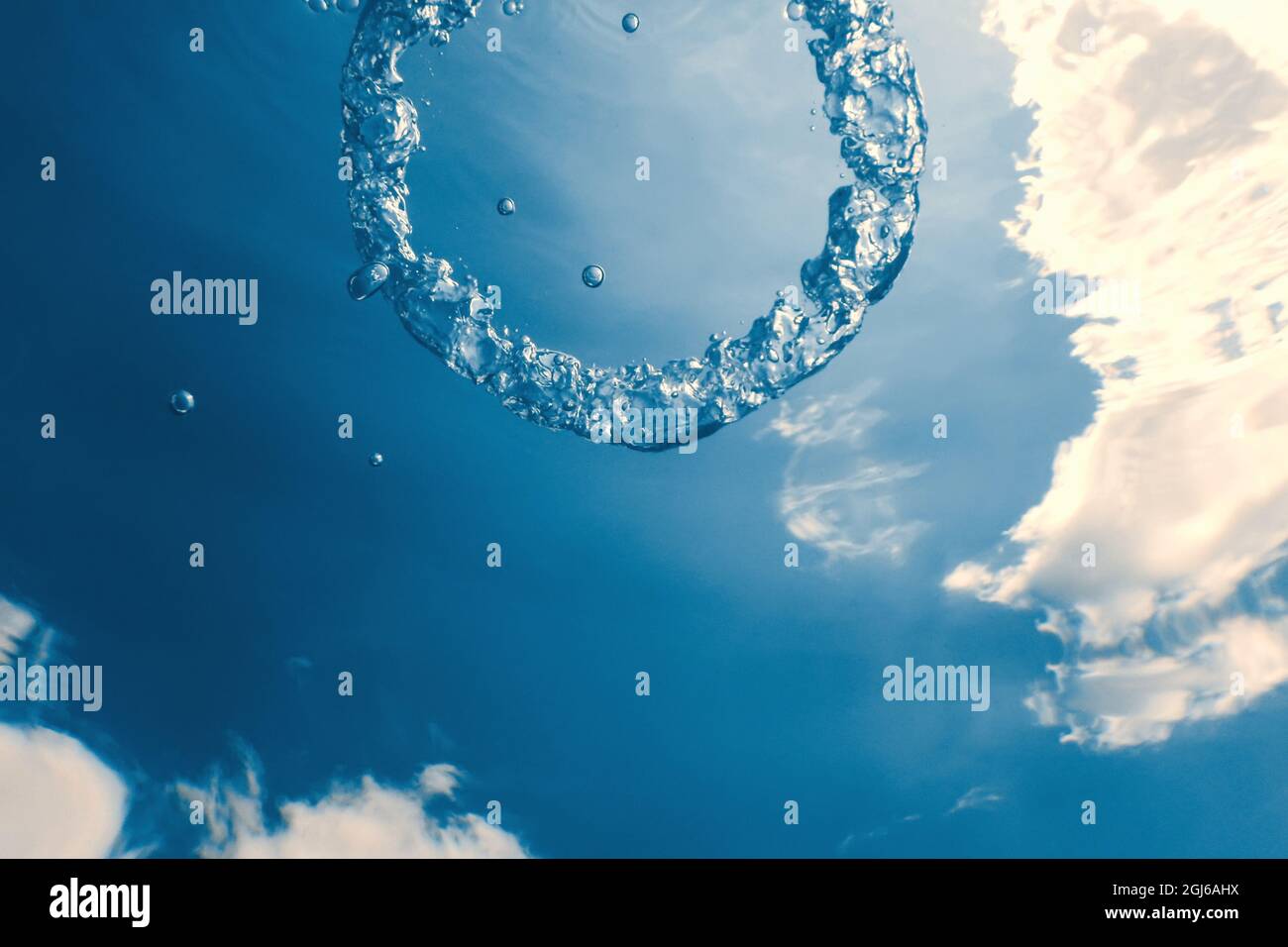 Bubble ring Underwater ascends towards the sun Stock Photo - Alamy