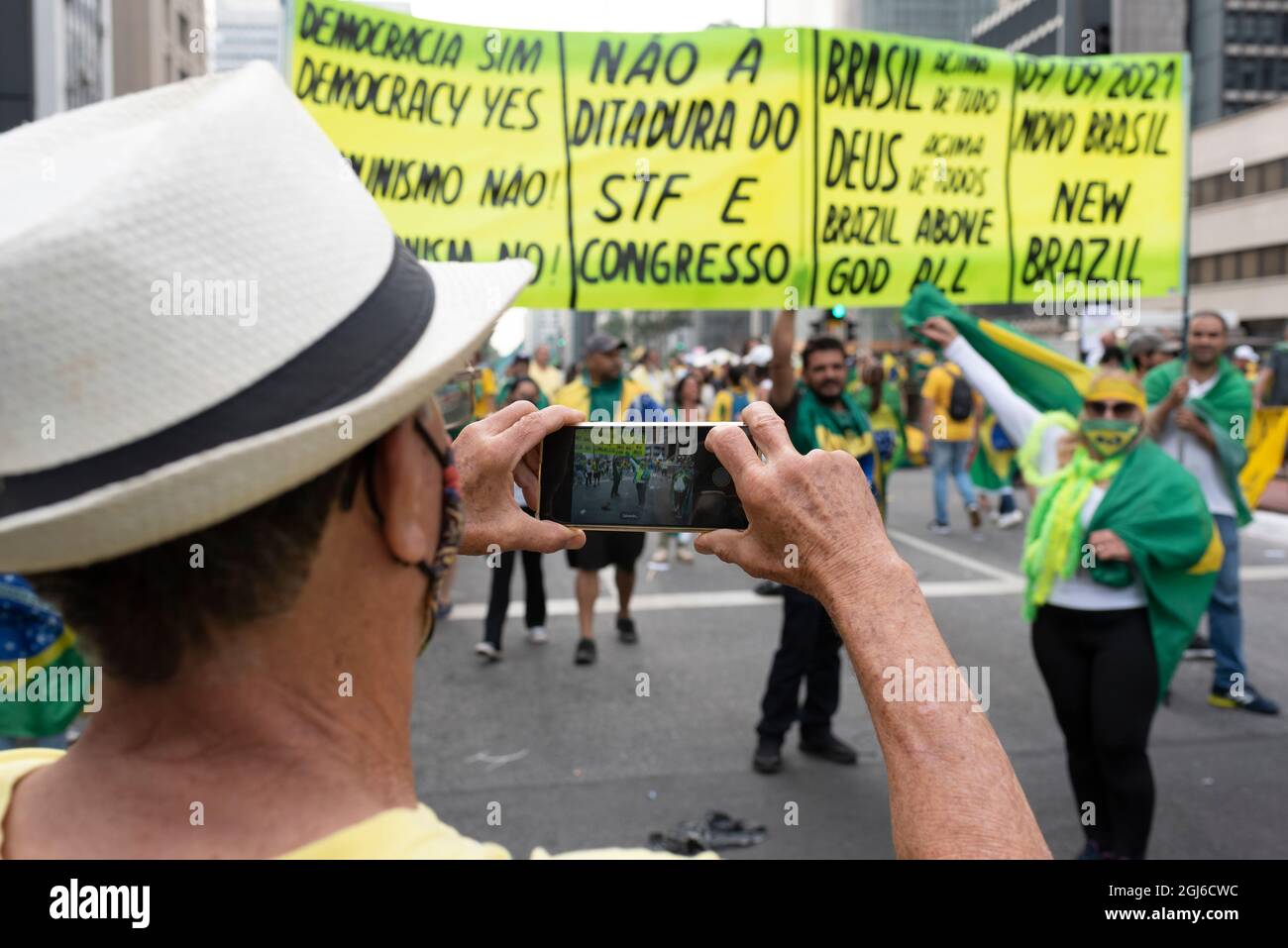 A Brazilian woman taking pictures of slogans during public displays ...
