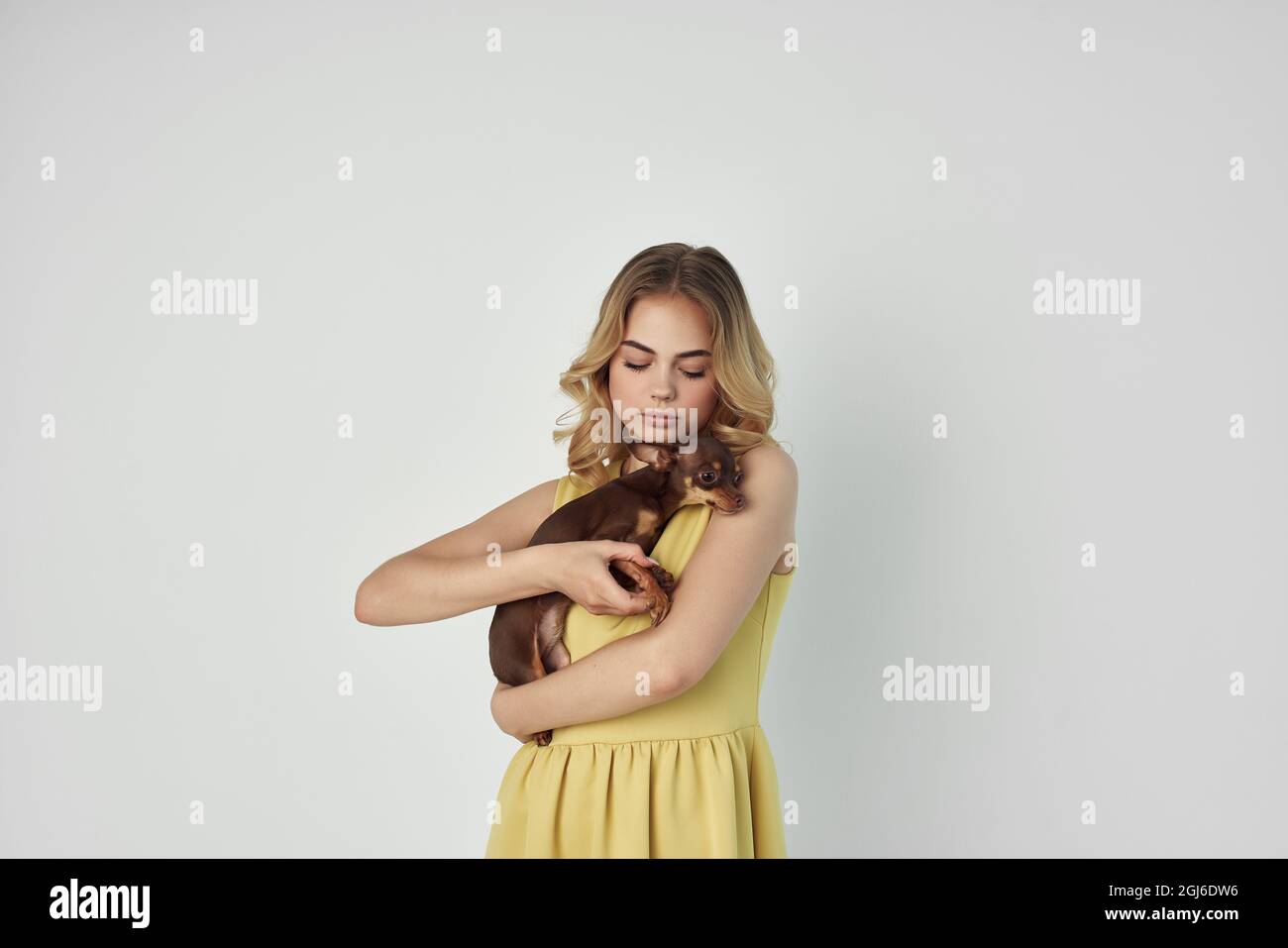 woman fashionable hairstyle light background Studio Stock Photo - Alamy