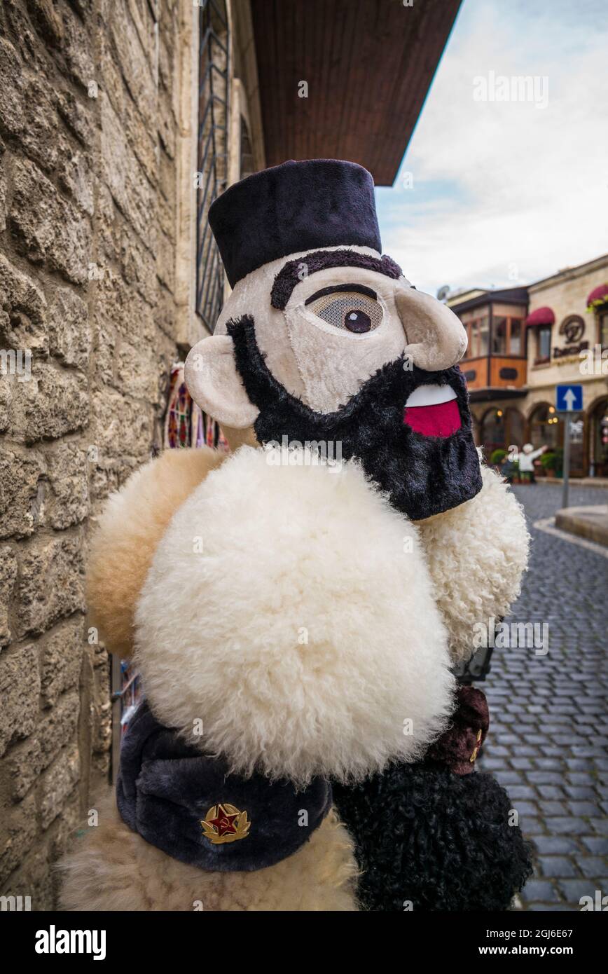 Azerbaijan, Baku. Old City, statue of Azeri man outside a fur shop ...