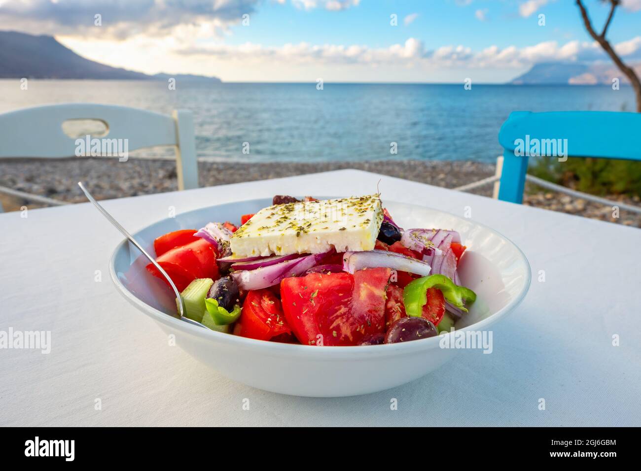 Traditional greek salad on a table in seaside tavern at Kissamos. Crete ...
