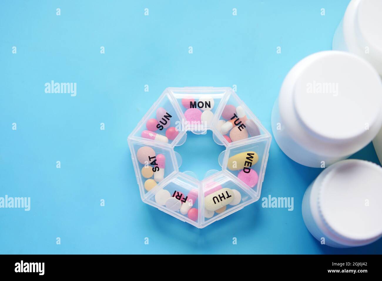 medicine pill box and container on blue background Stock Photo - Alamy