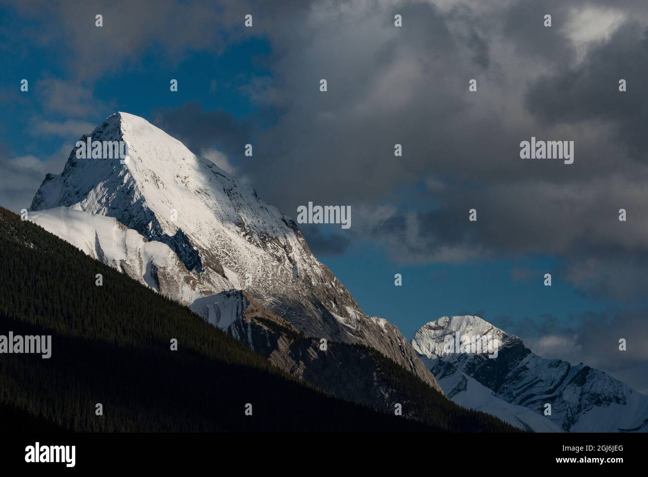 Canada, Alberta. Leah and Samson Peaks, with snow and clouds, Maligne ...