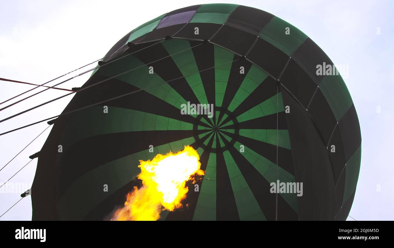 Adventure on hot air balloon watermelon. Burner directing flame into ...