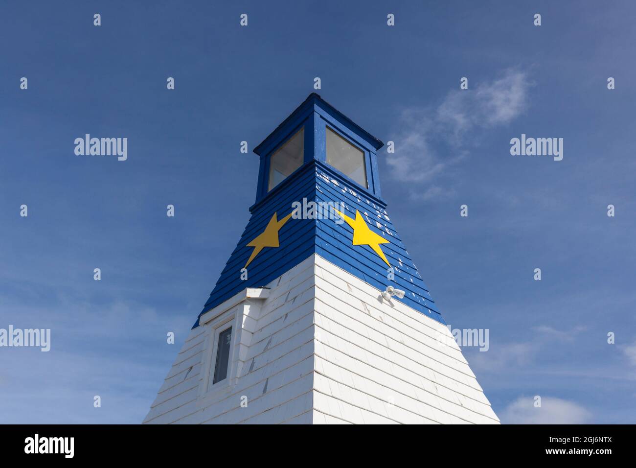 Canada, Nova Scotia, Cabot Trail. Cheticamp, town lighthouse painted in ...