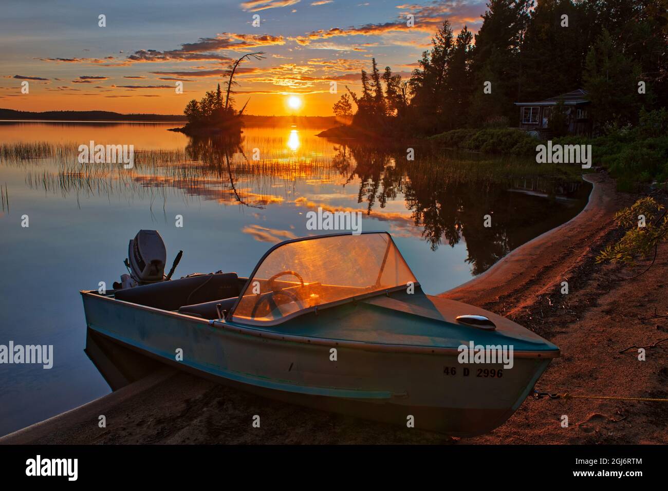 Canada, Quebec, Belleterre. Boat and sunset on Lac des Sables. Credit ...