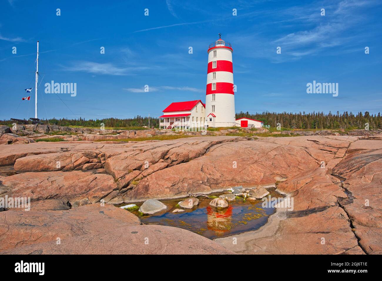 Canada, Quebec, Pointe-des-Monts. Lighthouse on shore of St. Lawrence ...