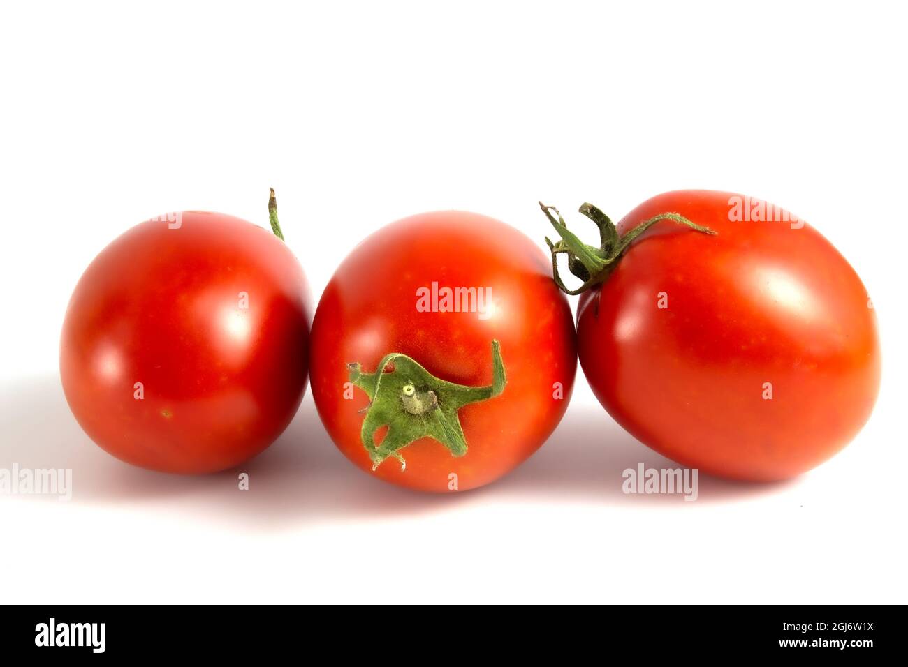 Three tomatoes isolated on white background Stock Photo - Alamy