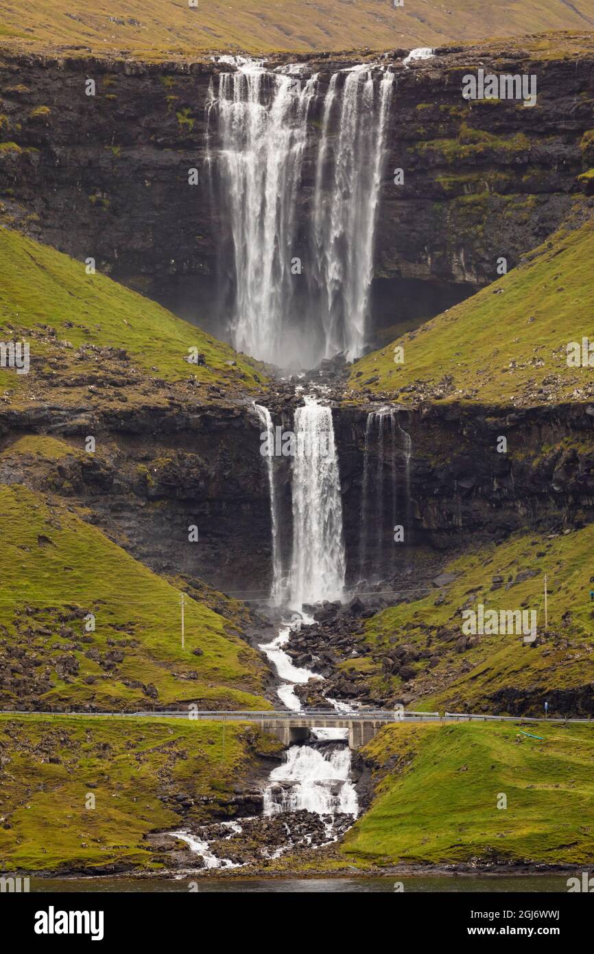 Europe, Faroe Islands. View of waterfall cascading down a hillside in ...