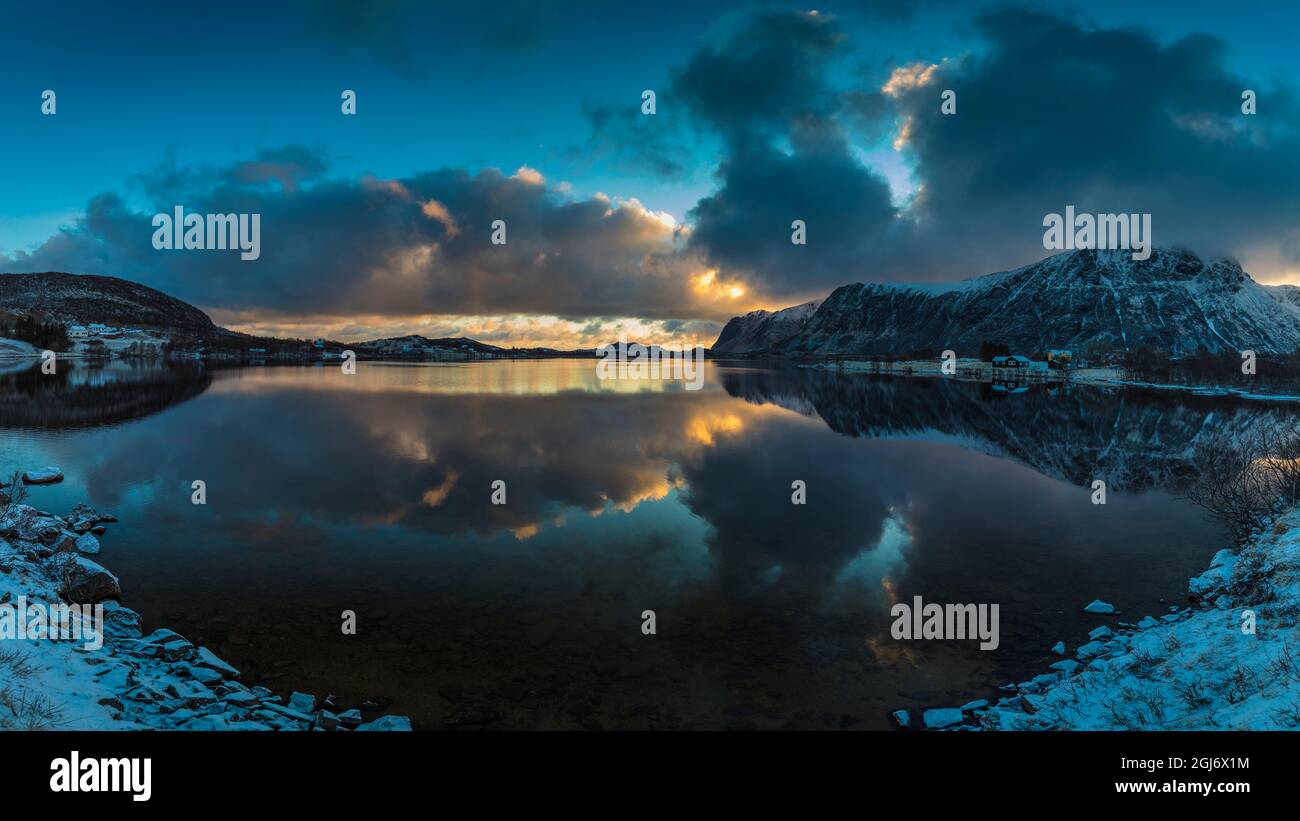 Europe, Norway. Snow covered mountains surround the still waters of ...