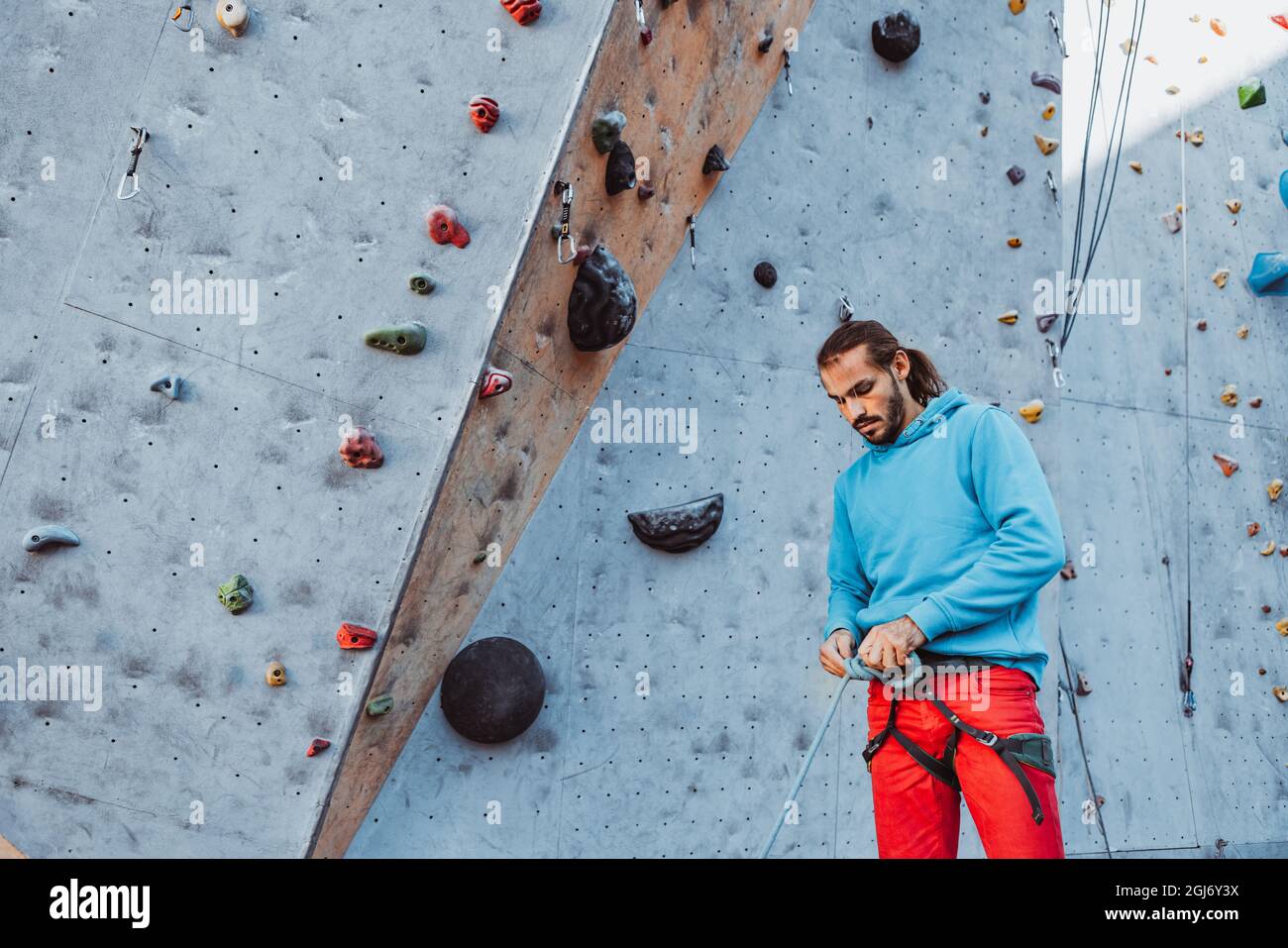 Safety climbing. Young man professional rock climber checking sports ...
