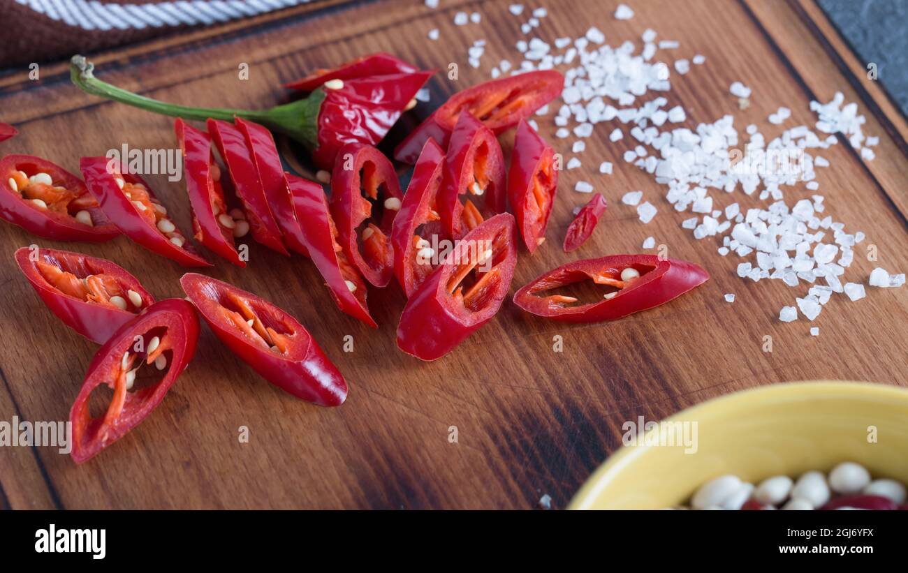 chili peppers, sliced on a kitchen board, macro Stock Photo - Alamy