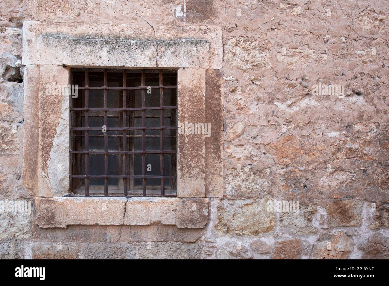 old window with bars, located in a medieval wall Stock Photo - Alamy