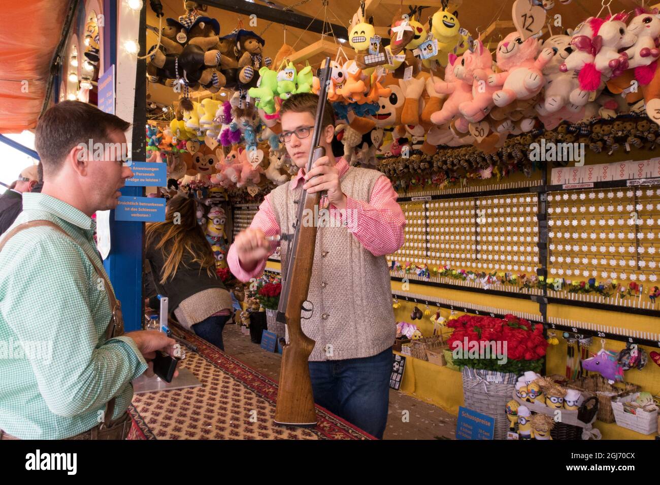 Man in traditional lederhosen playing carnival game during Oktoberfest ...