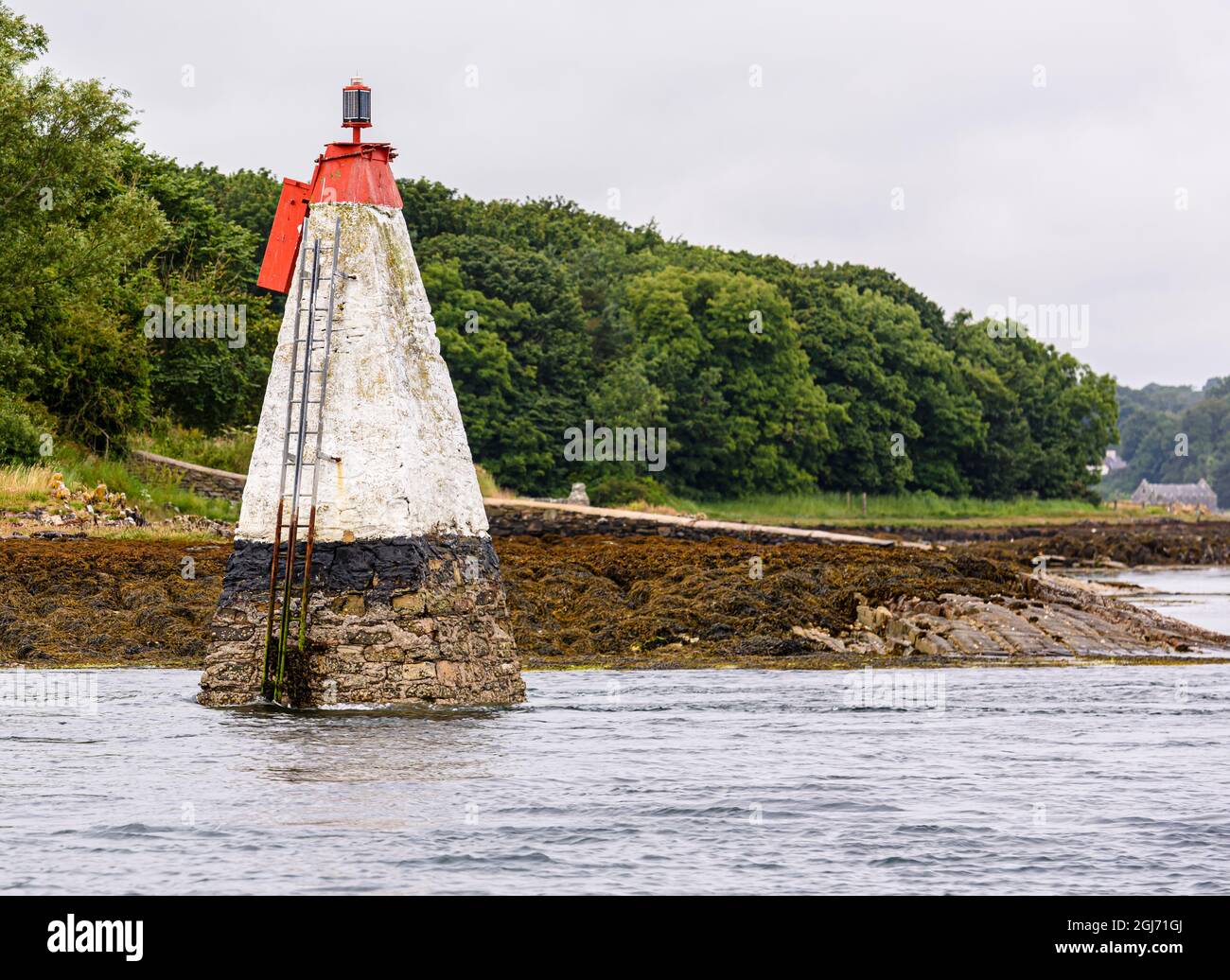 Conical concrete shipping navigation aid by the coast of Strangford ...