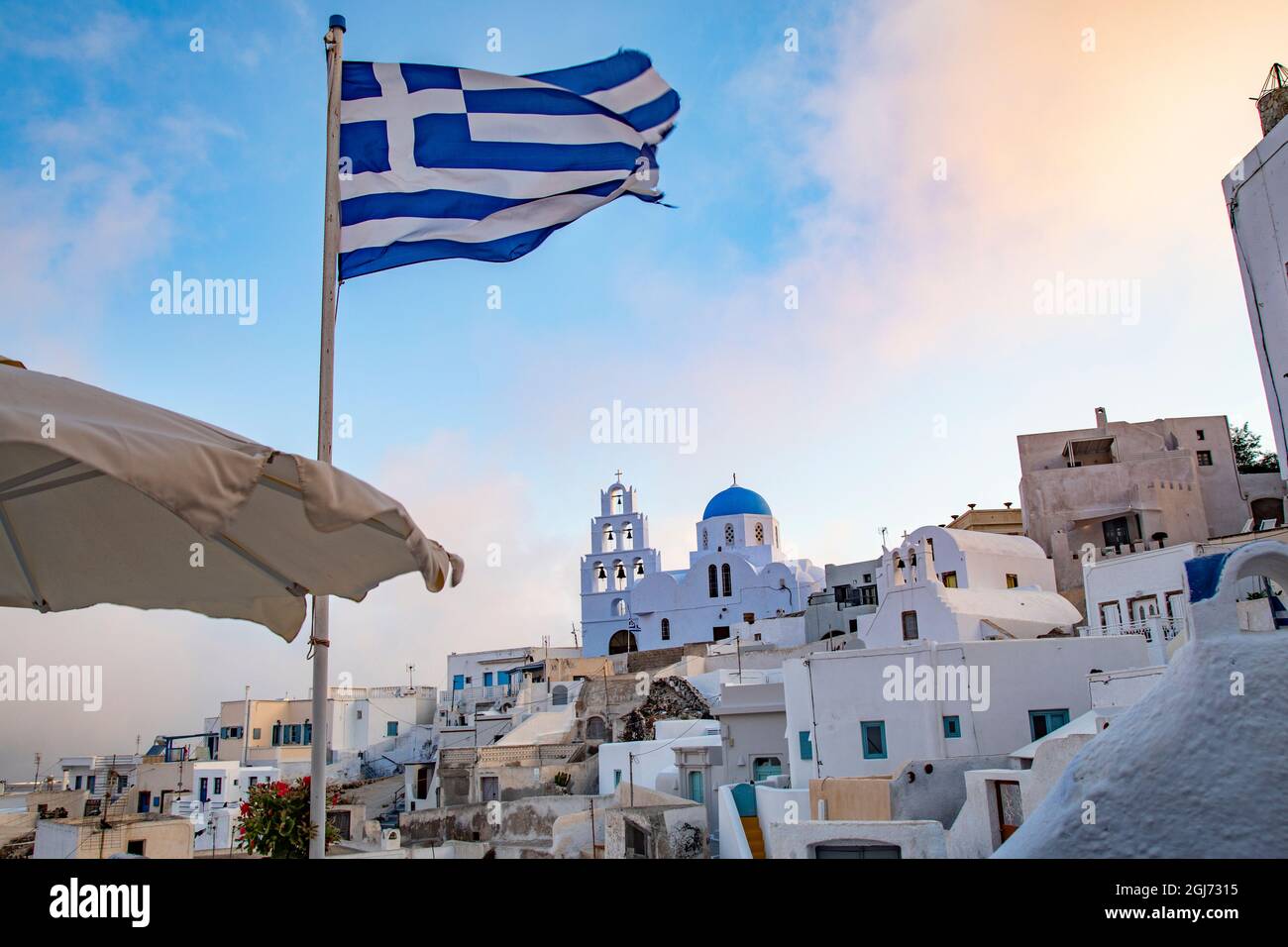 Greek flag flying in the wind of Fira, Santorini, Greece Stock Photo ...