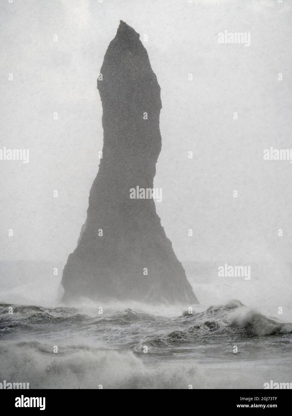 Coast near Vik y Myrdal during winter. The sea stacks Reynisdrangar ...