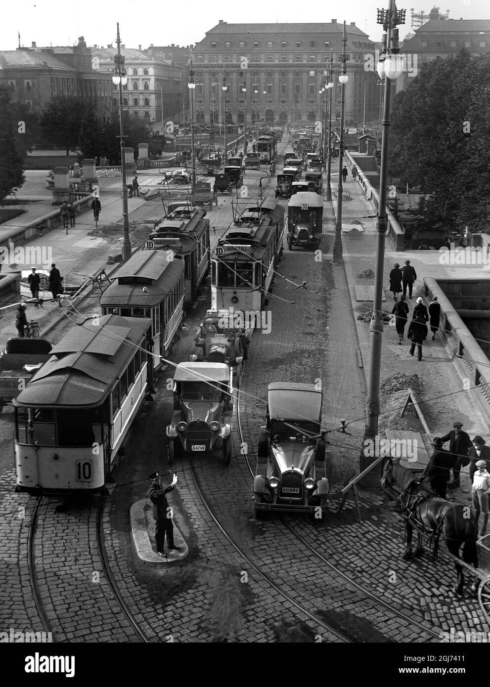 Cars and trams at Norrbro, a bridge from Gustav Adolfs torg (square) to ...