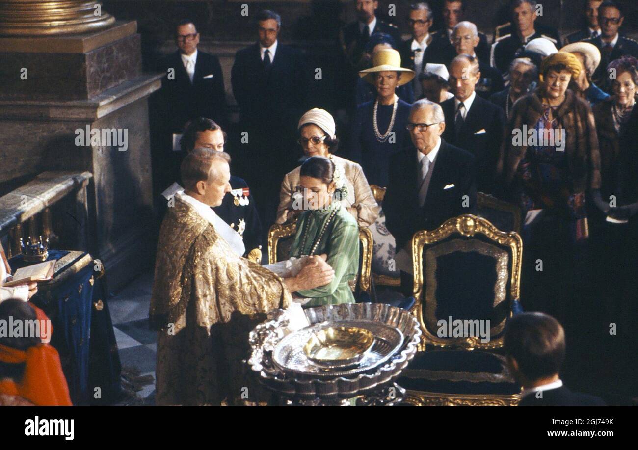 Swedish Queen Silva holds Princess Victoria in front of the Archbishop ...