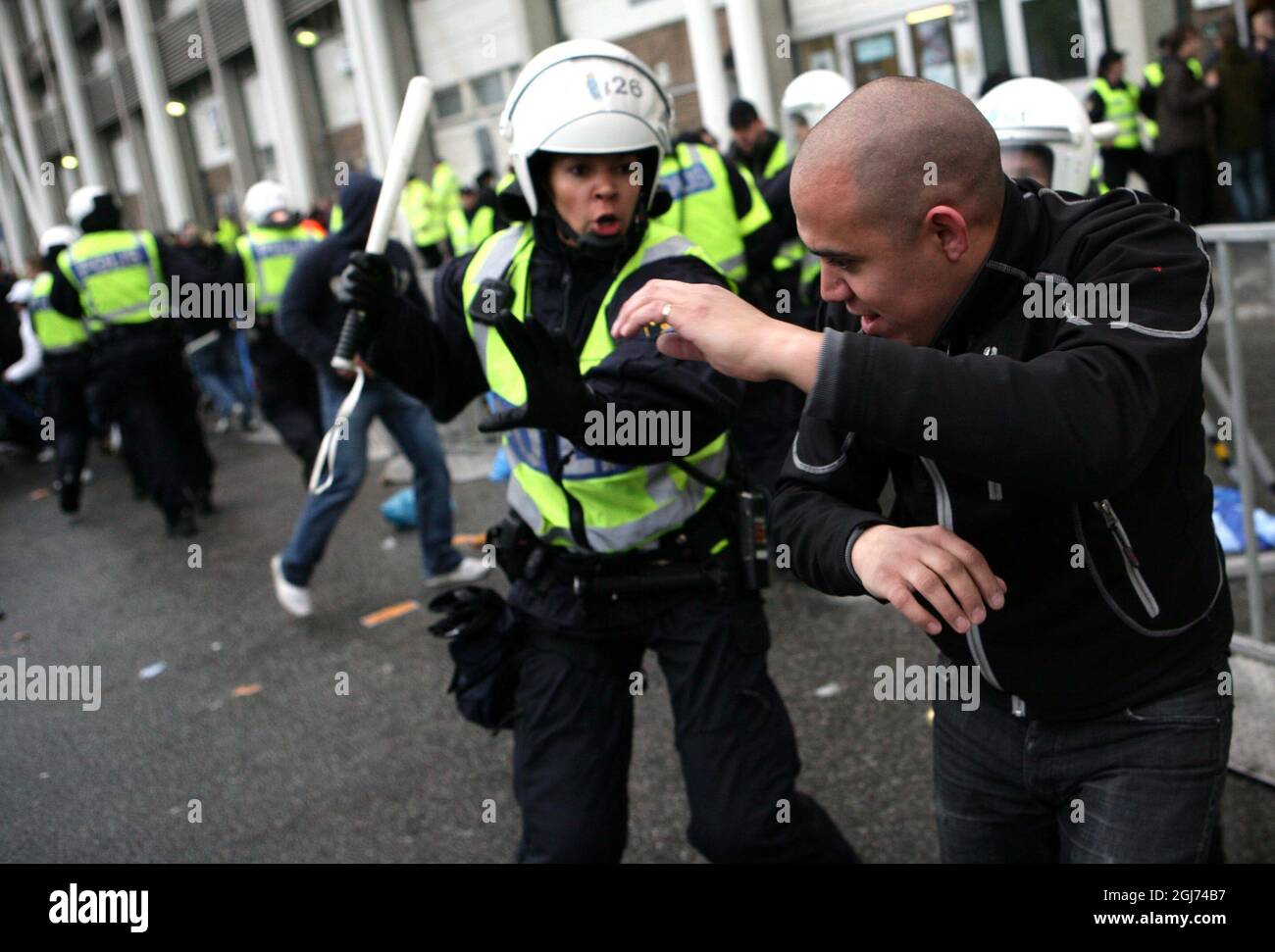 A Police officer engages with a football fan during the match Djurgarde ...