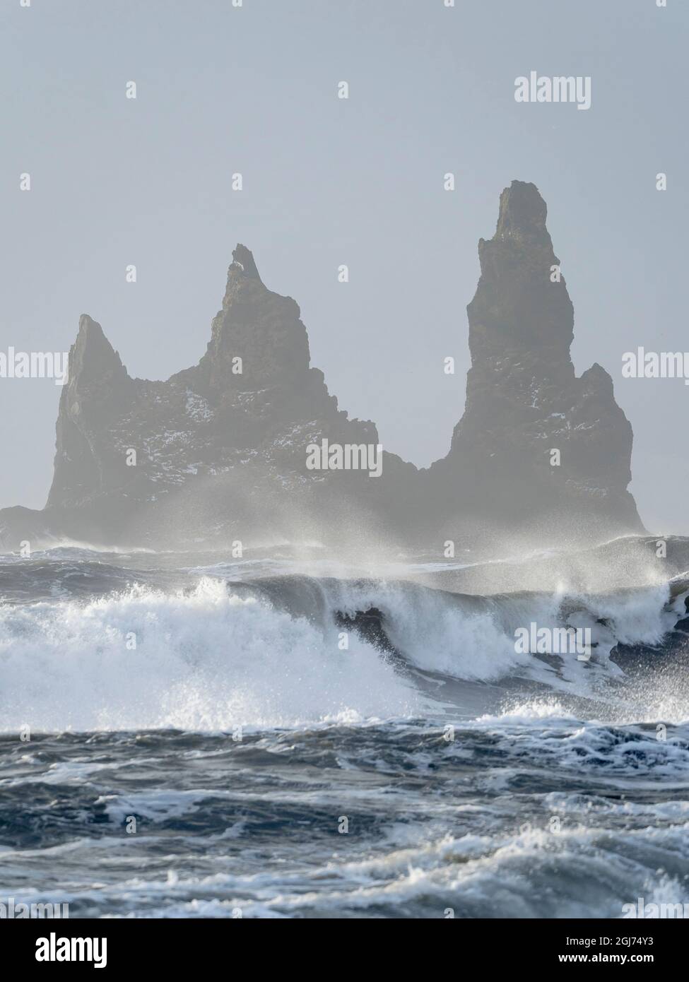 Coast near Vik i Myrdal during winter. The Reynisdrangar sea stacks ...