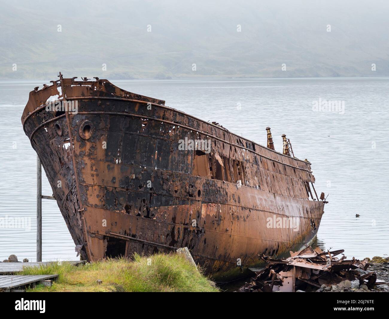 Landscape at Reykjarfjordur. The old fish factory and wreck. The ...