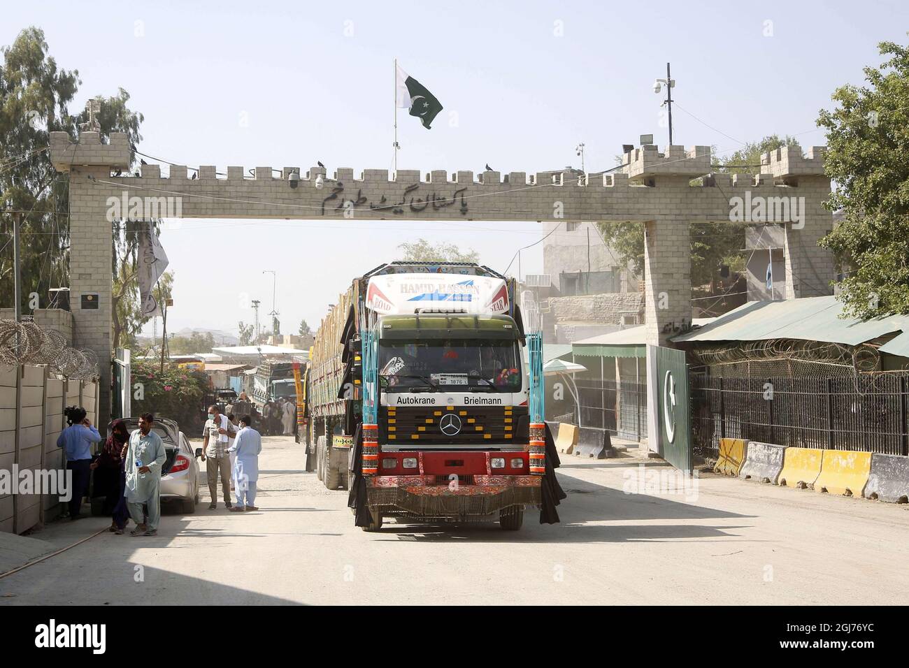 TORKHAM, Sept. 9, 2021 (Xinhua) -- Trucks enter Pakistan at the border ...