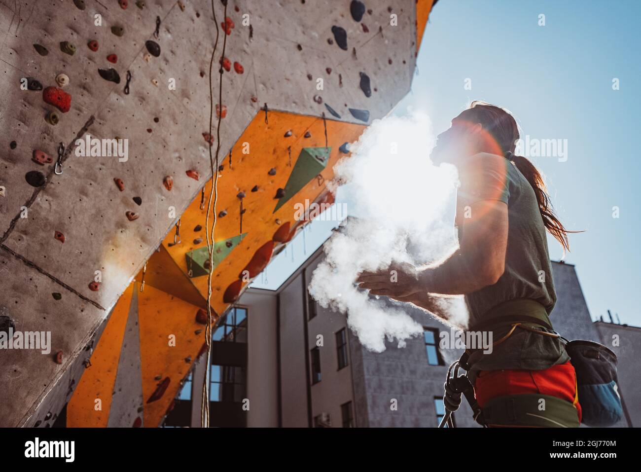 Young man professional rock climber practicing at training center in ...