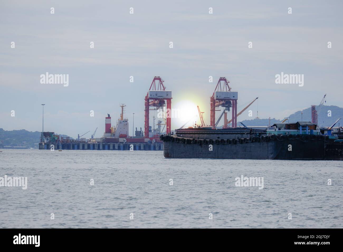 cargo ship full of sand sunset Stock Photo - Alamy