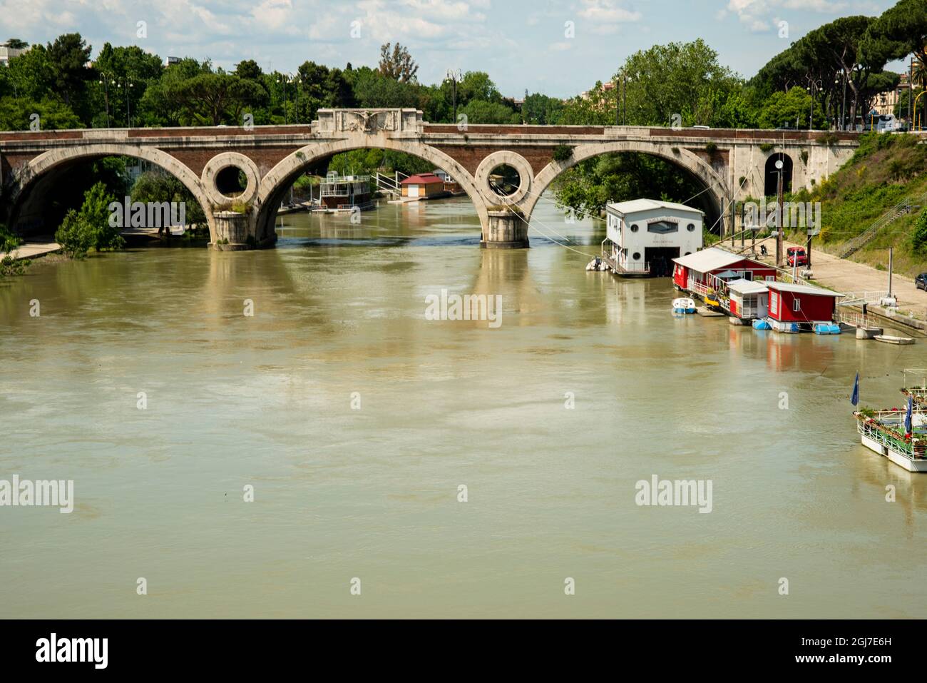 Italy, Rome. Tiber River and boats along Lungotevere Arnoldo da Brescia ...