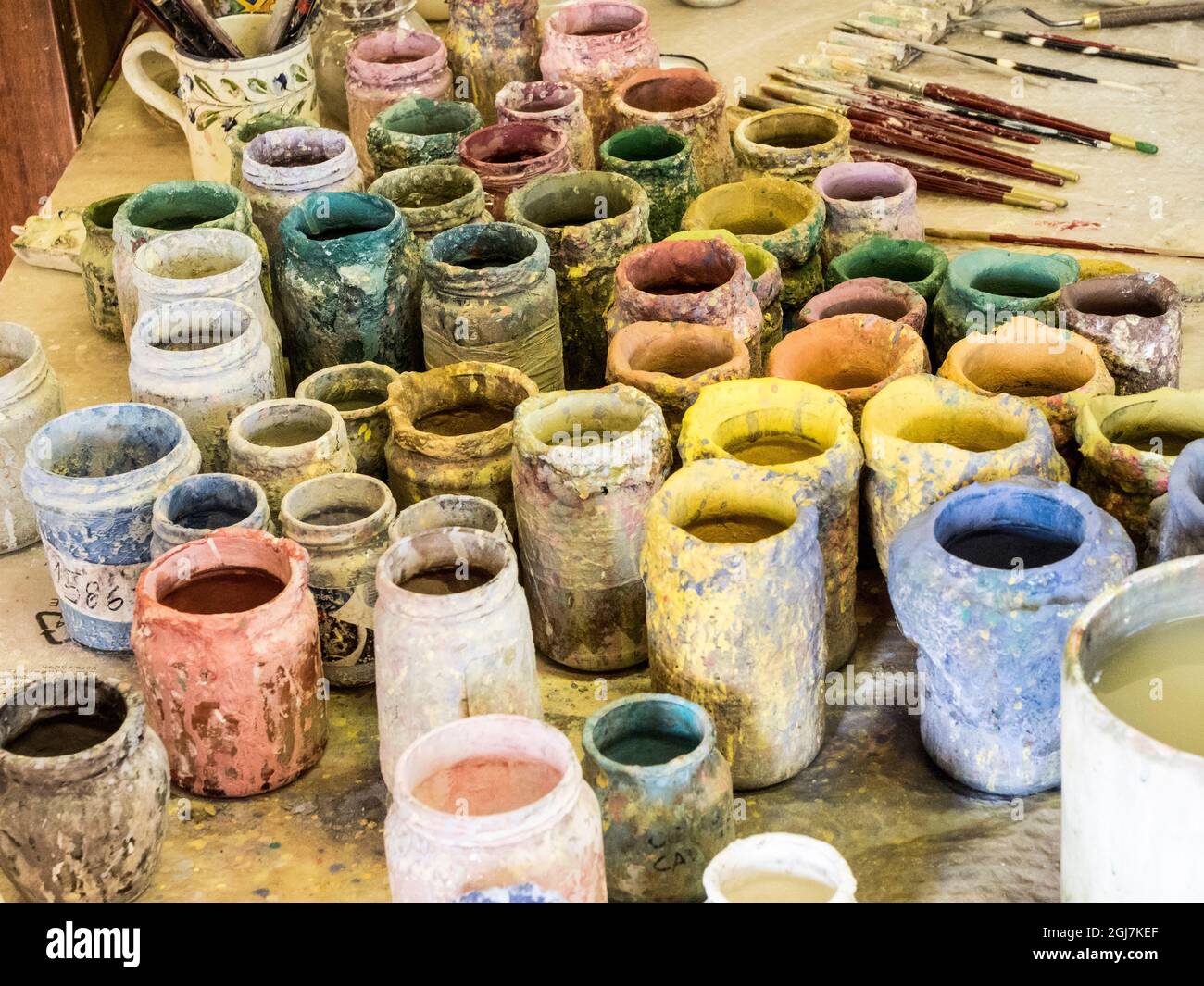Europe, Italy, Chianti. Jars of different paint colors in a pottery ...