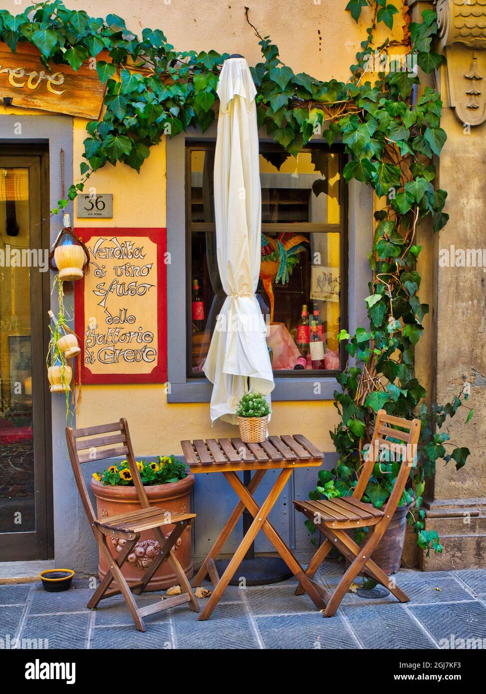 Europe, Italy, Chianti. Table and chairs set up outside a cafe in Radda ...
