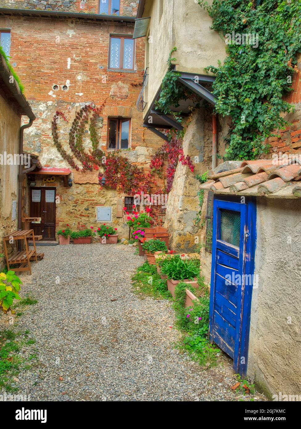 Europe, Italy, Chianti. Back street alleyway with bright blue hand ...