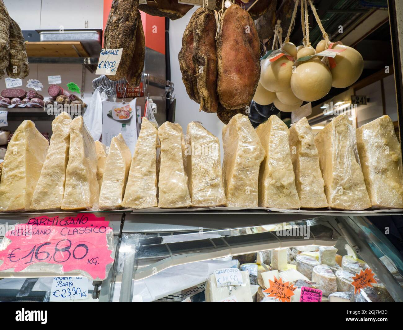 Italy, Florence. Large chunks of Parmigiano-Reggiano cheese in a shop ...