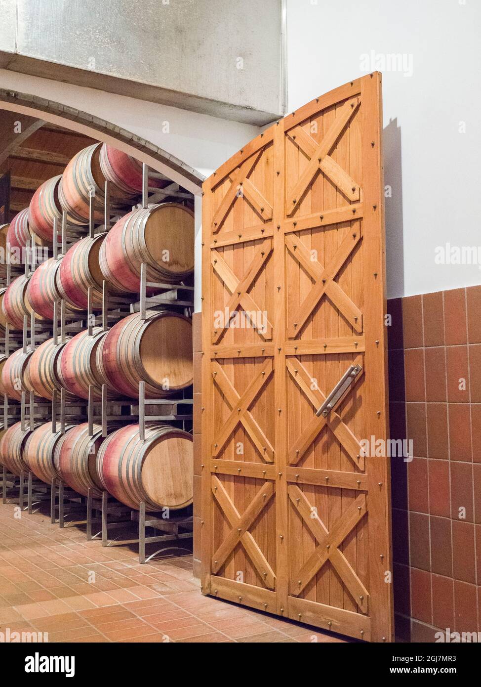 Italy, Tuscany. Beautiful wooden doors leading to a barrel room at a ...