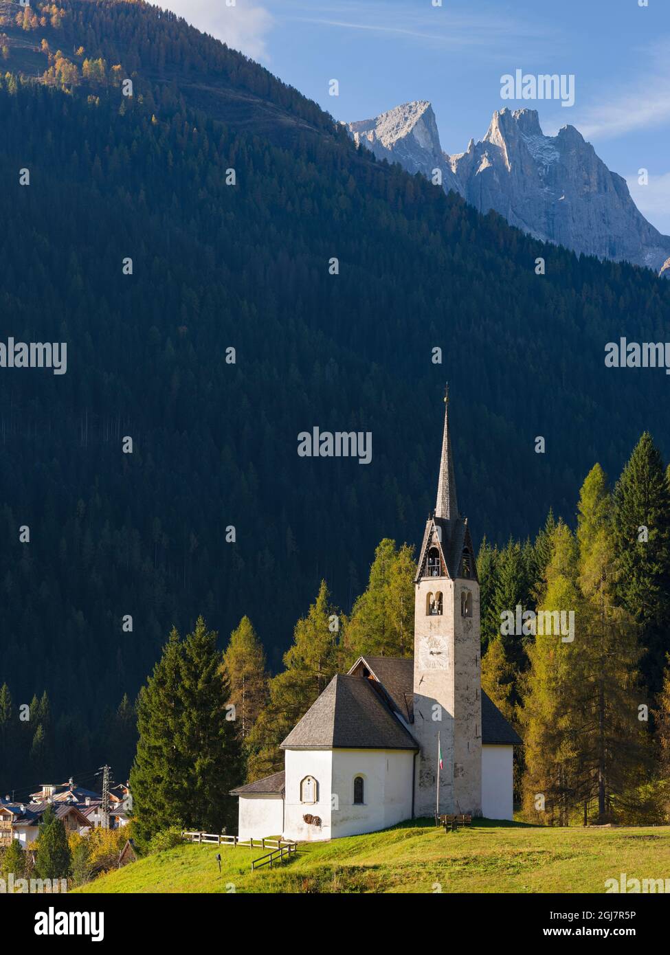 The church, in the background Focobon mountain range in the Pale di San ...