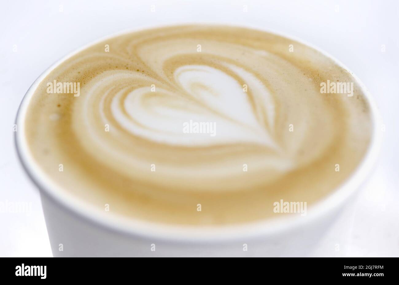 A paper cup cafe latte with heart design in foam Stock Photo - Alamy