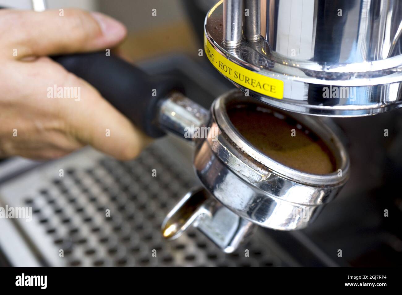 Man using an espresso machine to make coffee Stock Photo - Alamy
