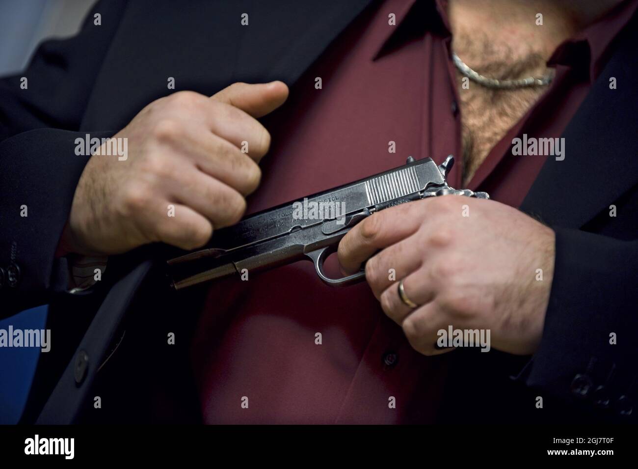 Man holding gun ready to shoot Stock Photo - Alamy