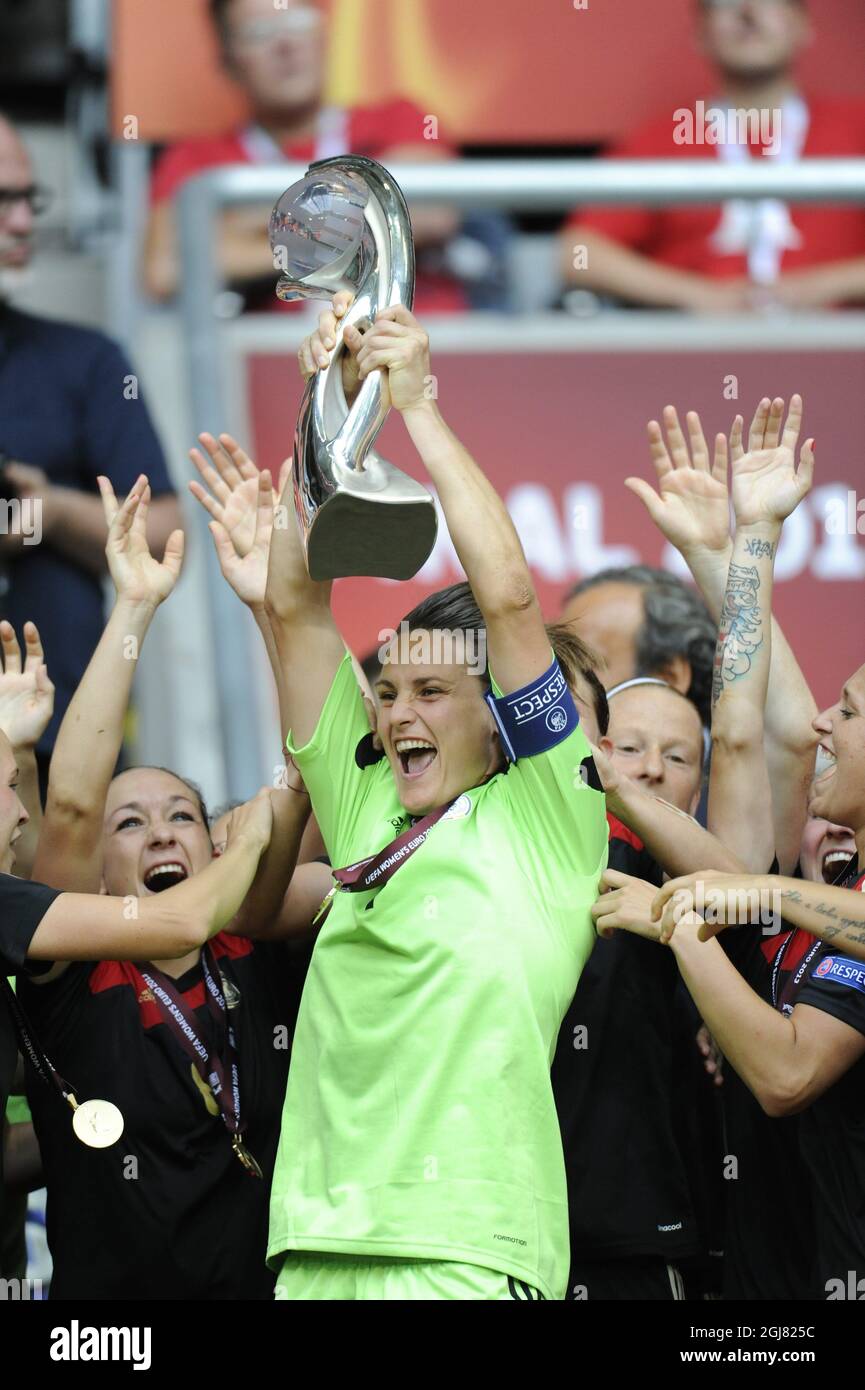 Germany's goalie Nadine Angerer hoists the trophy after the victory by ...