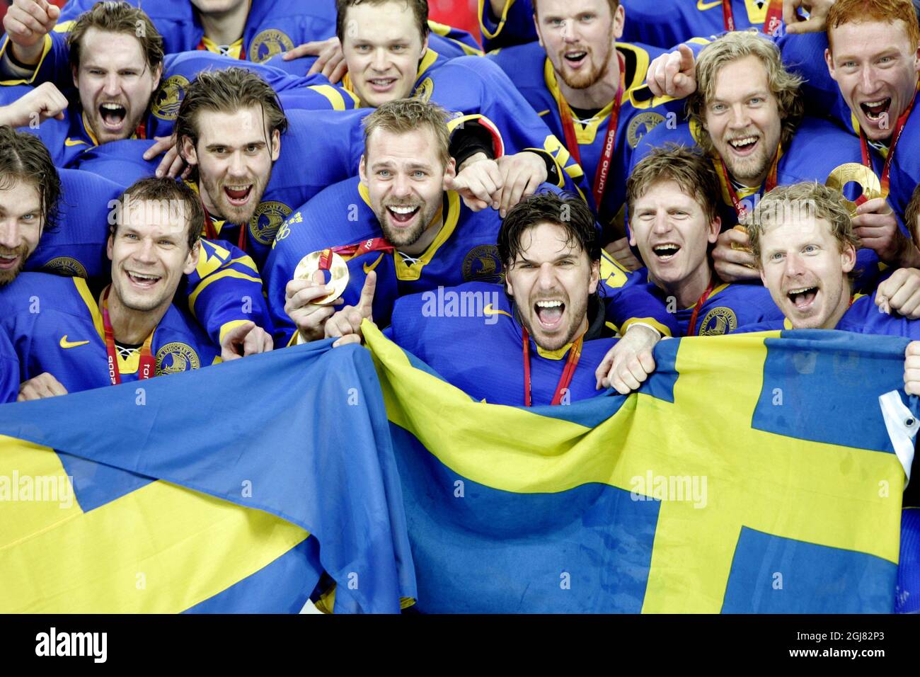 The Swedish team celebrate with flags gold medals medals and flowers ...